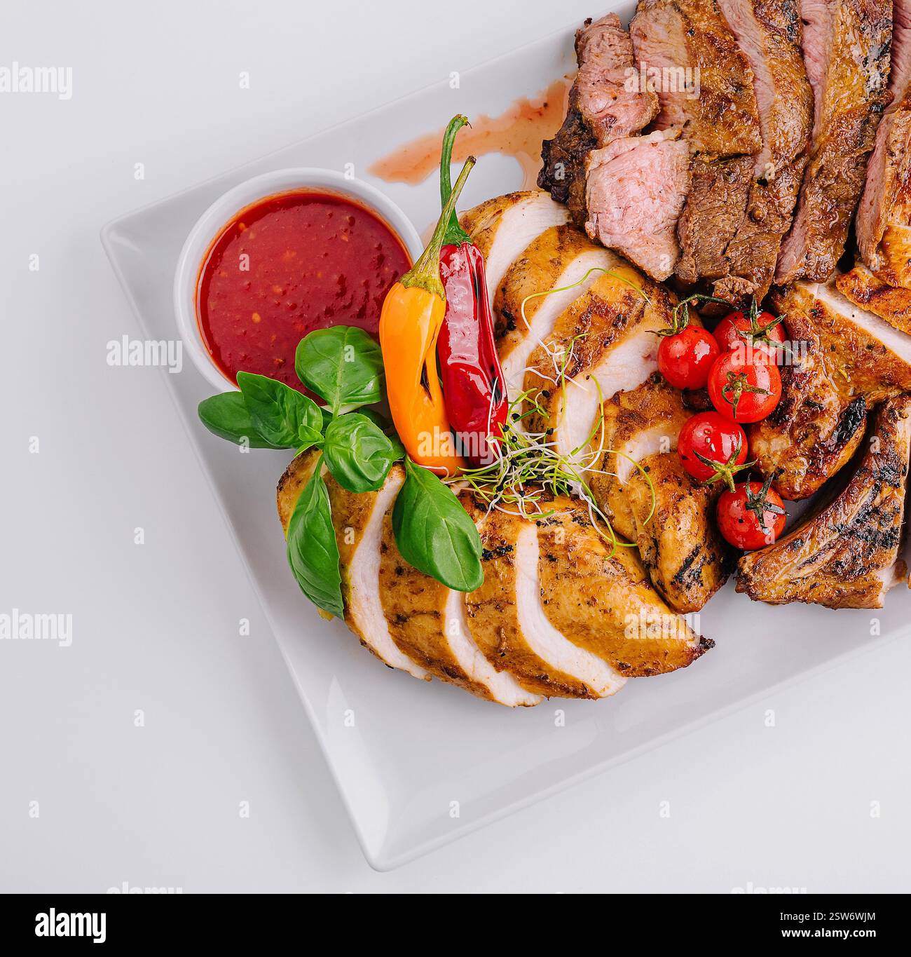 Gourmet grilled meat platter with fresh vegetables Stock Photo - Alamy