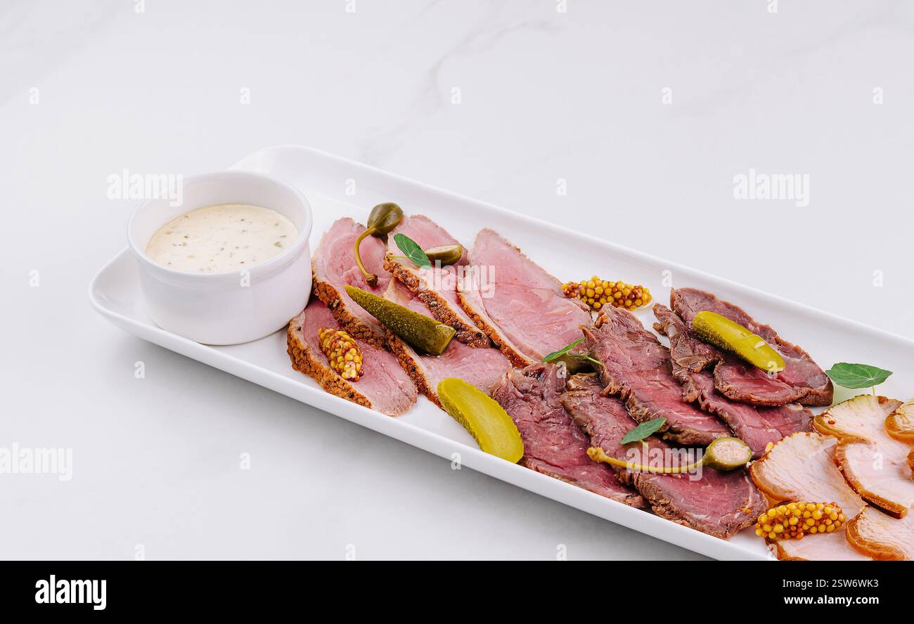 Elegant deli meat platter with sauce Stock Photo - Alamy