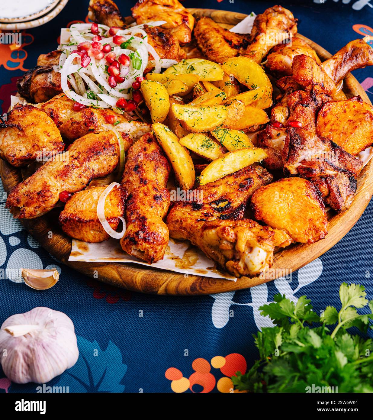 Traditional spicy roasted chicken and potatoes feast Stock Photo - Alamy