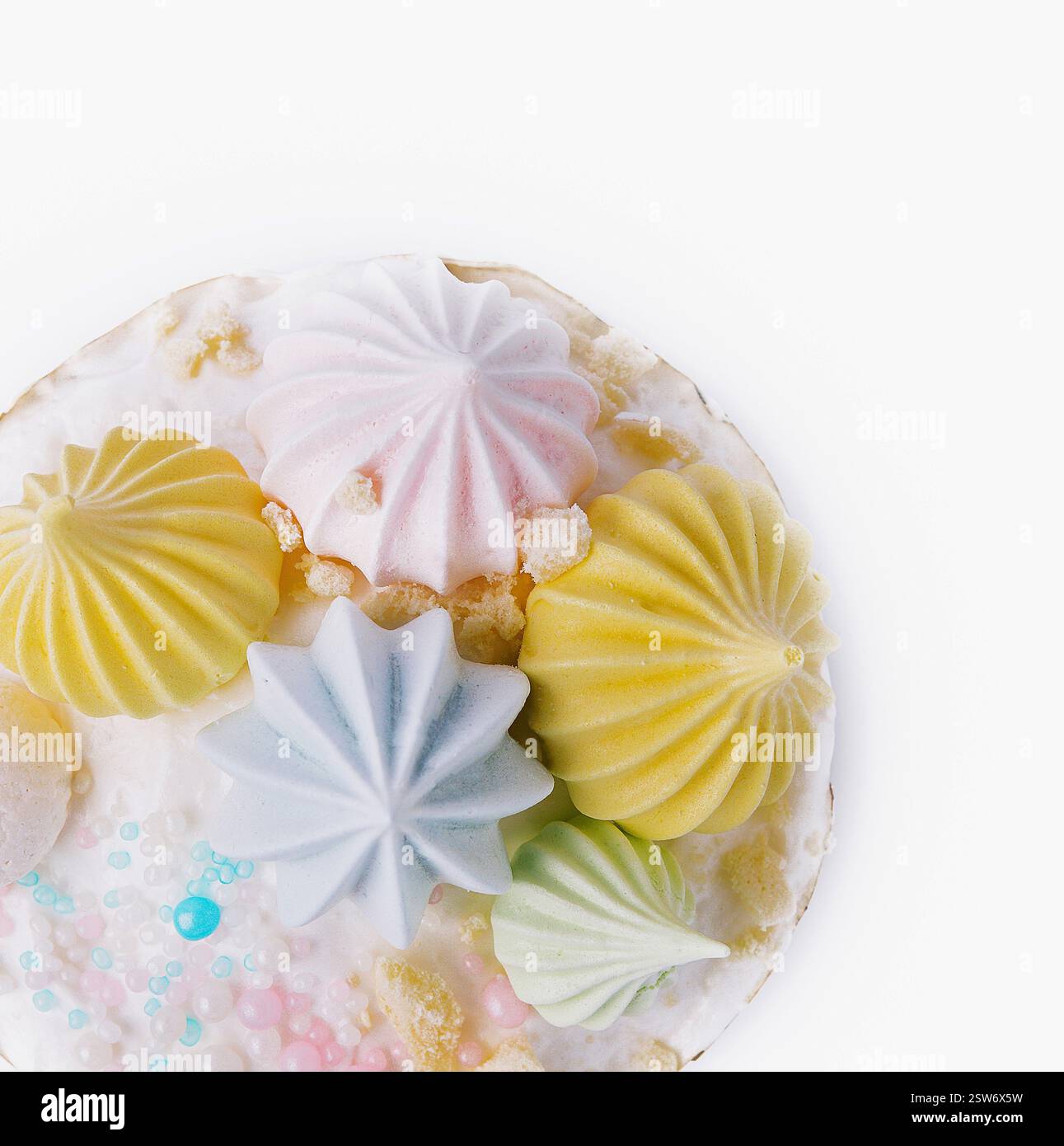 Colorful meringue topped cake on white background Stock Photo - Alamy
