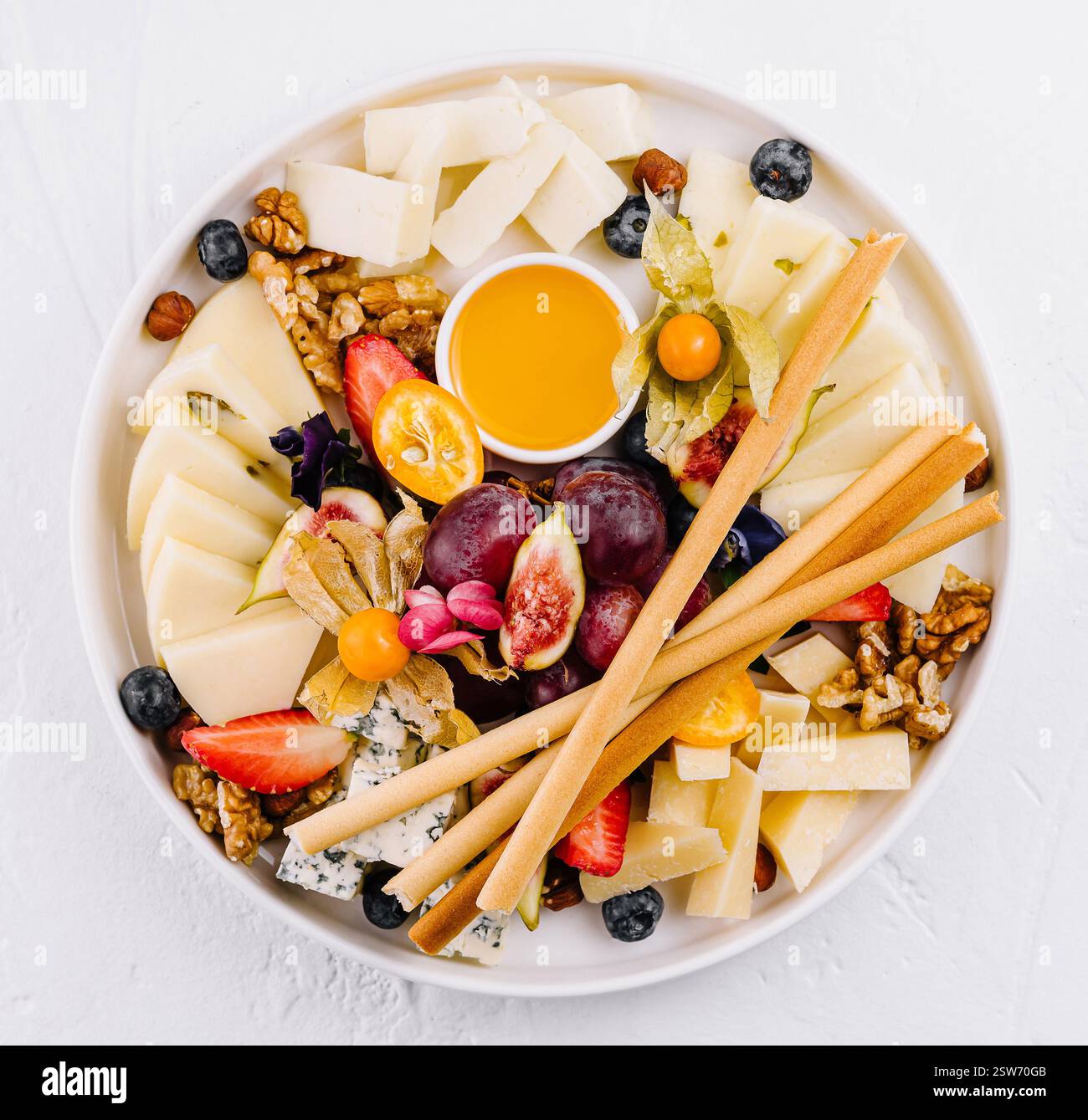 Gourmet cheese platter with fruits and nuts Stock Photo - Alamy