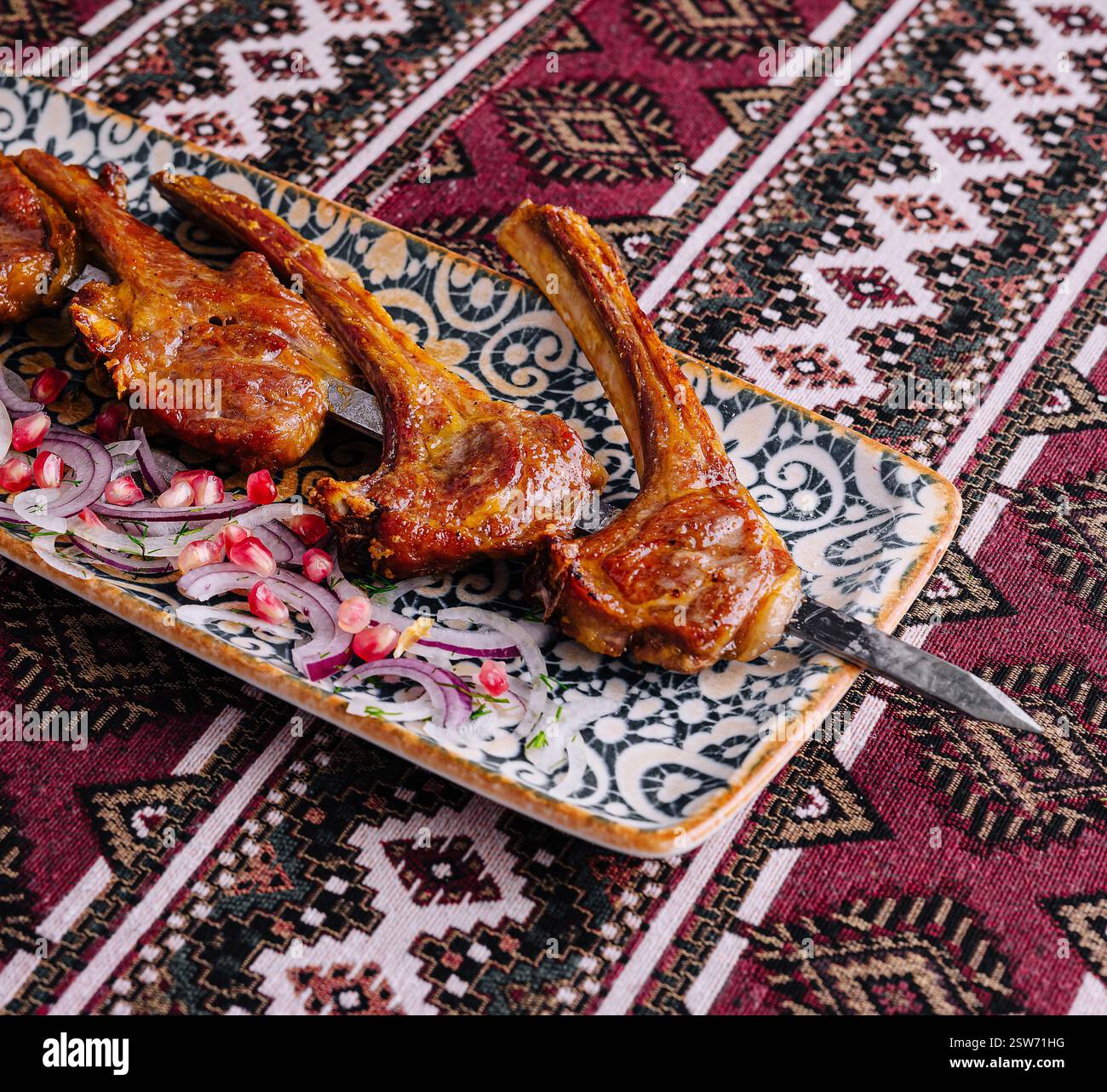 Spicy grilled lamb chops on ornate plate Stock Photo - Alamy