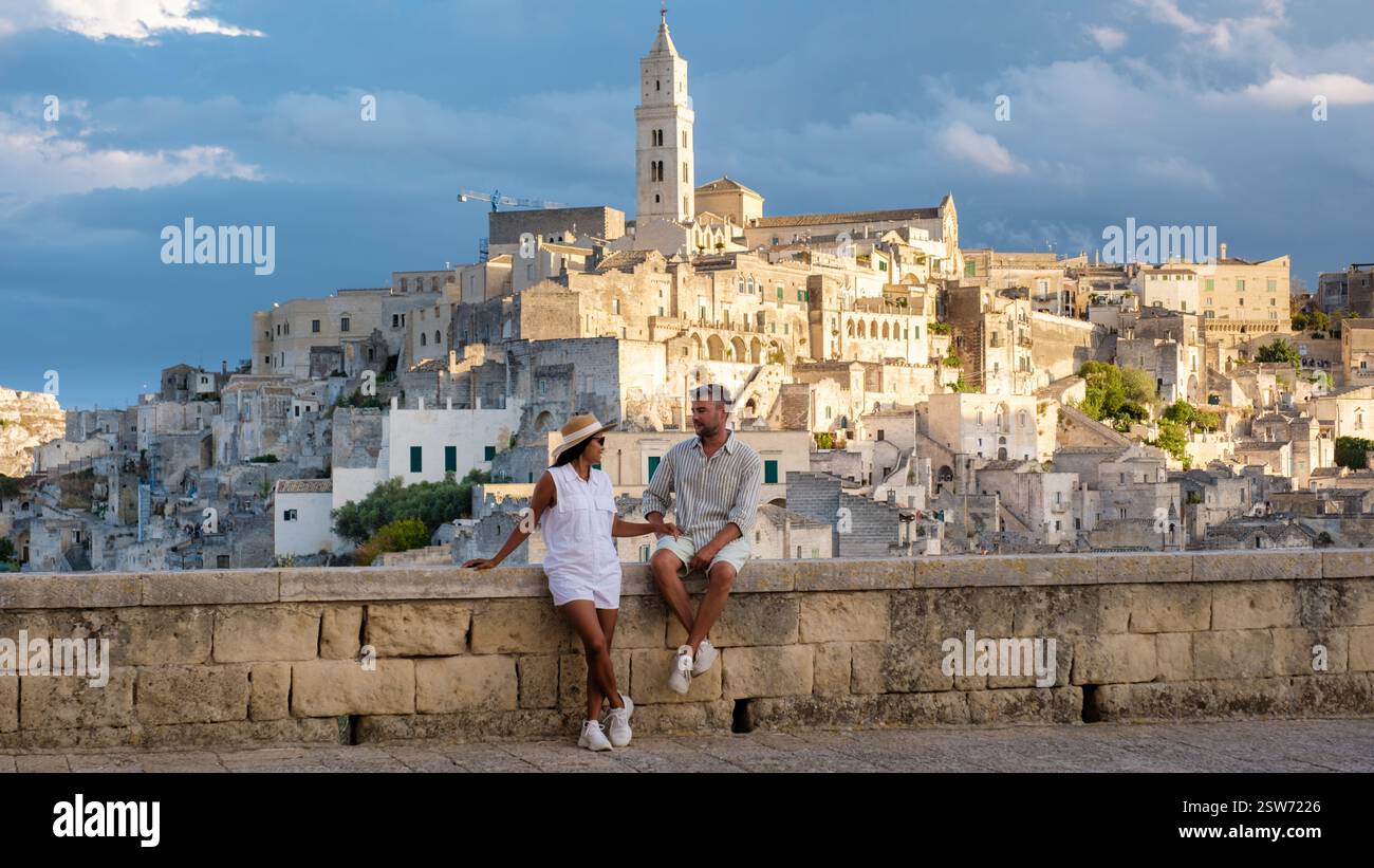 A couple enjoys the stunning sunset view over Matera ancient stone ...