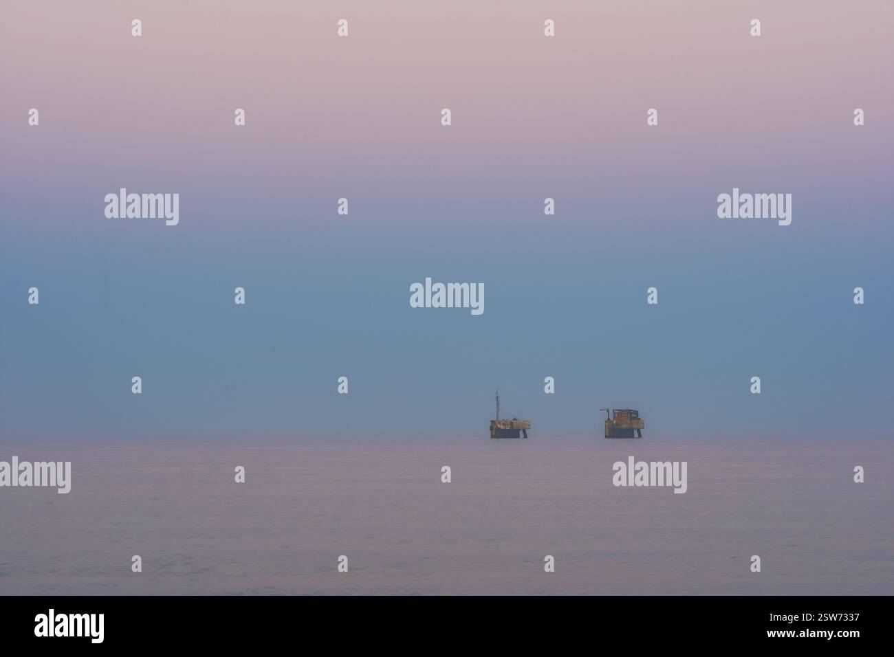 Guadalmar's marine structures. Twilight scene with moon. Two weathered ...