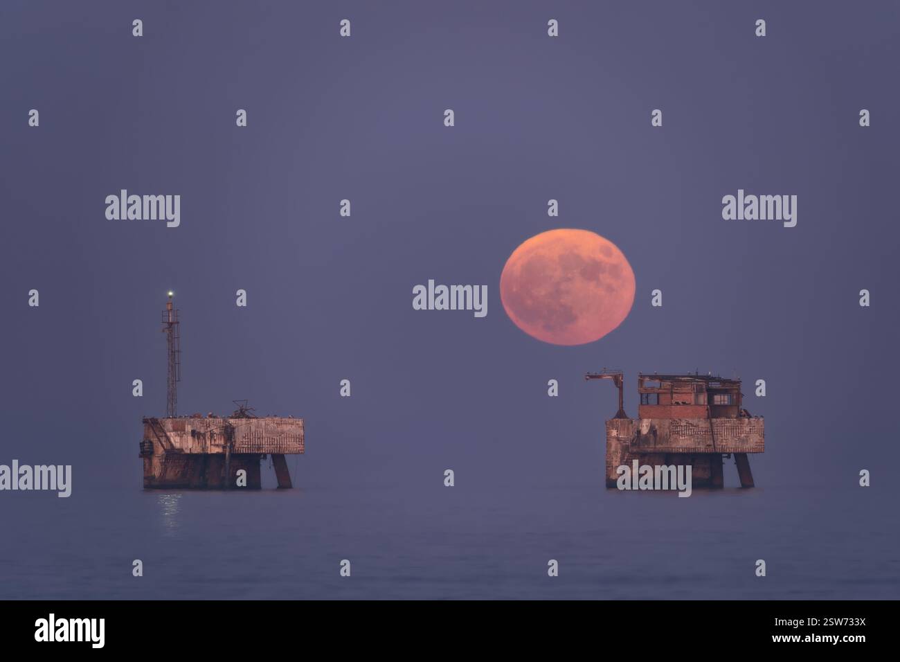 Guadalmar's marine structures. Twilight scene with moon. Two weathered ...