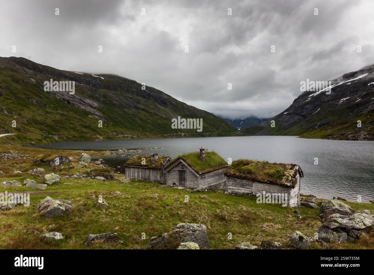 Traditional Norwegian house with grass roof standing alone in the fjord ...