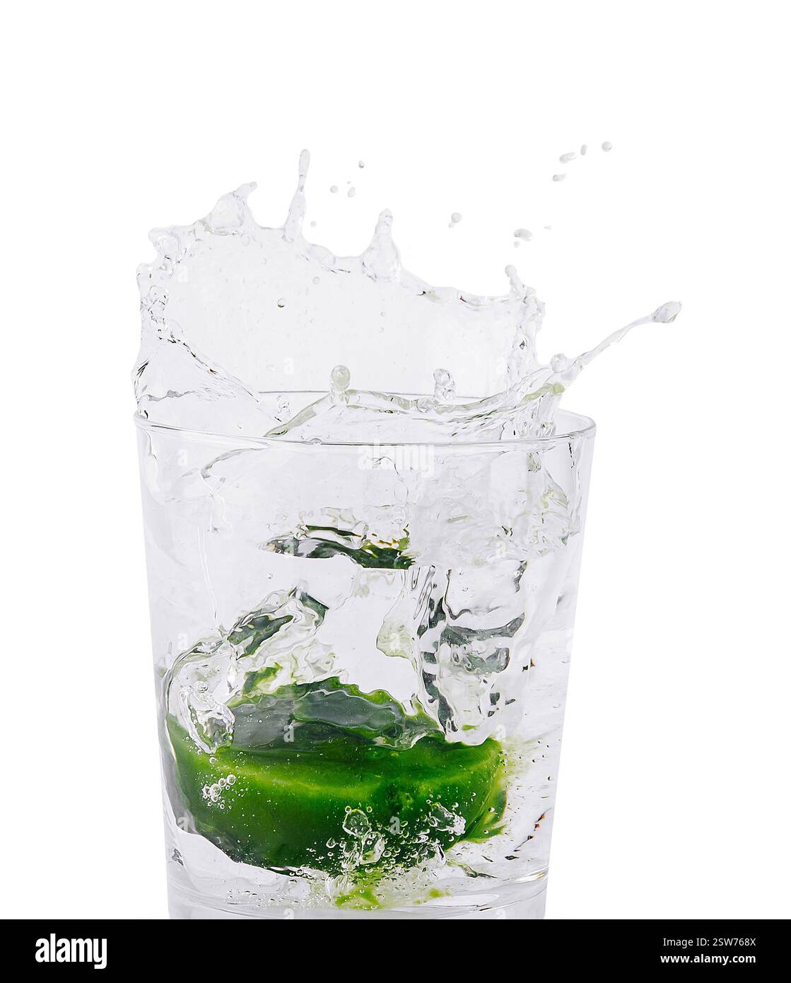 Lime slice dropping into a clear glass of water, creating a dynamic splash, isolated on a white ...
