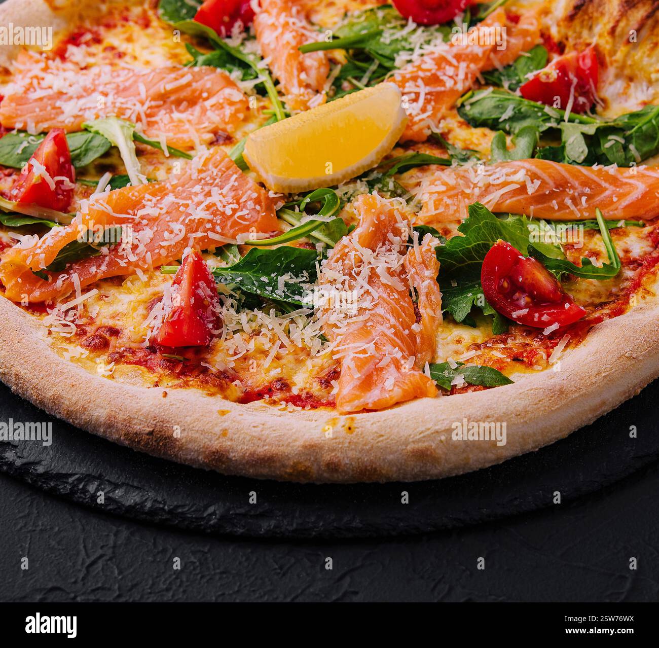 Gourmet smoked salmon pizza on dark background Stock Photo - Alamy