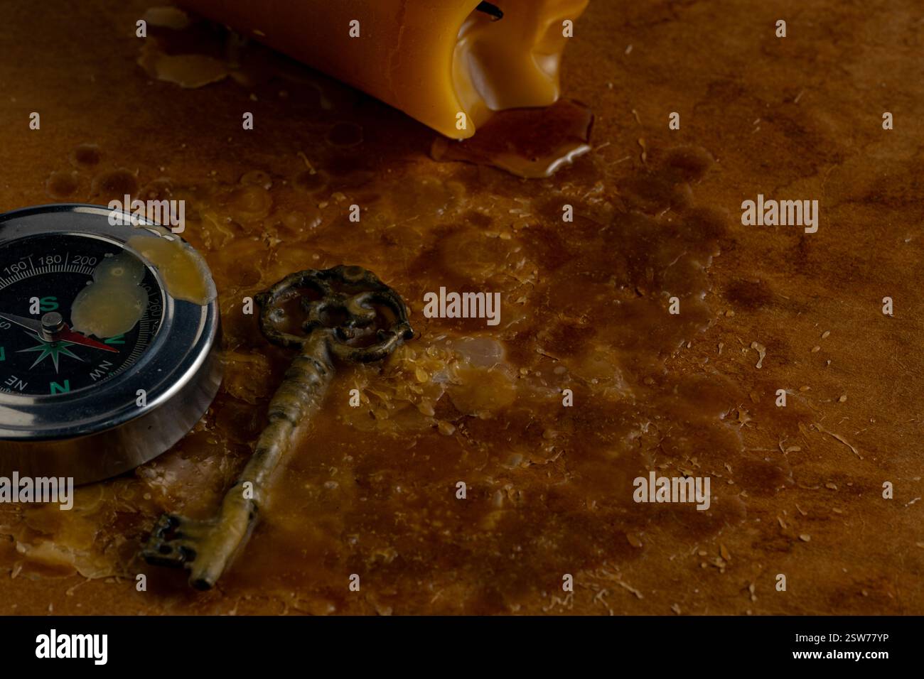 Compass and vintage key on brown paper background. Closeup Stock Photo ...