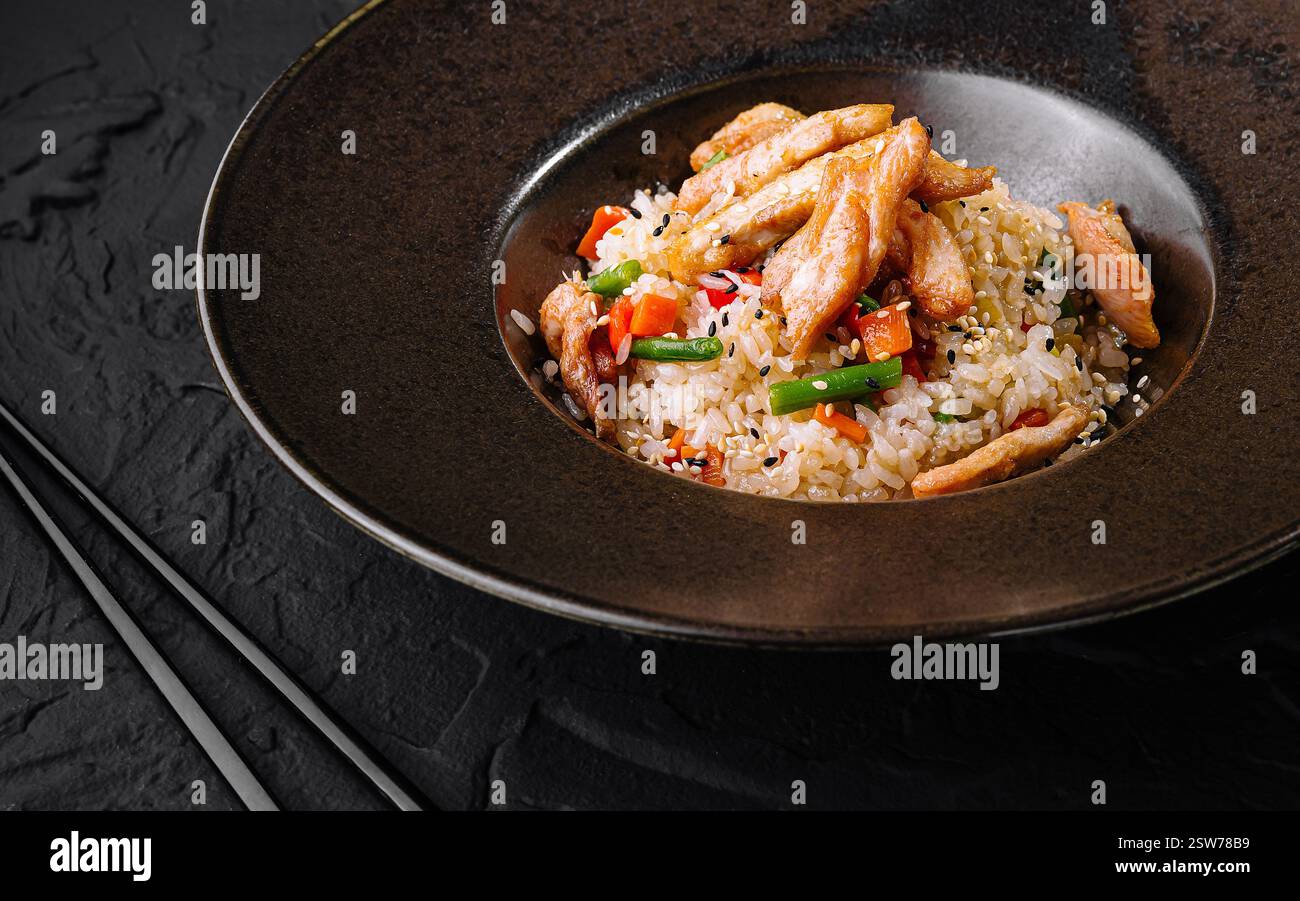 Asian chicken fried rice on elegant plate Stock Photo - Alamy