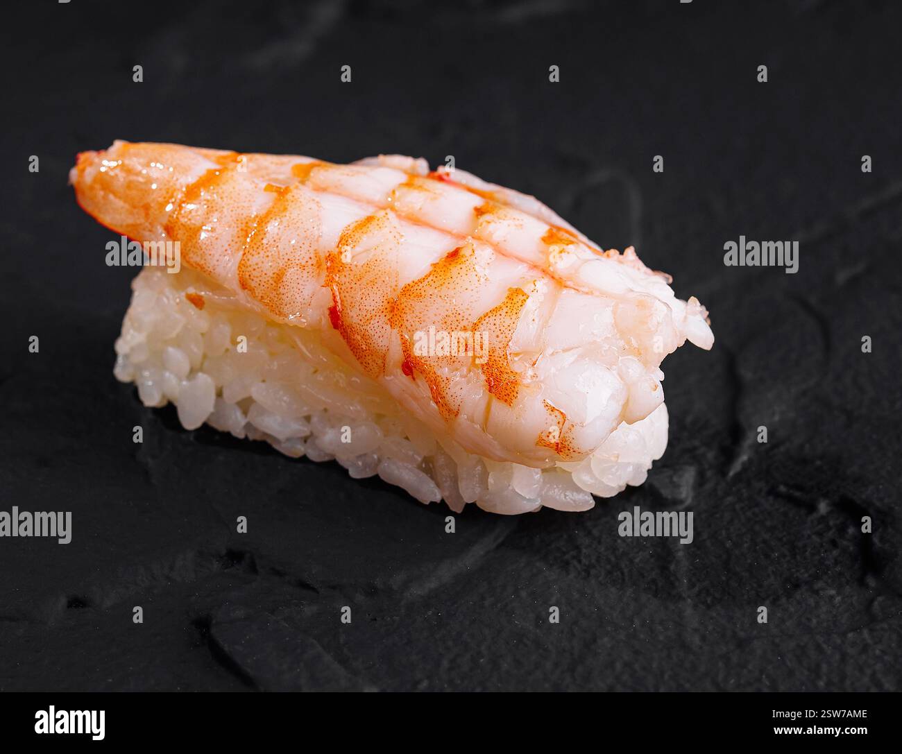 Close-up of a single shrimp sushi piece elegantly presented on a ...