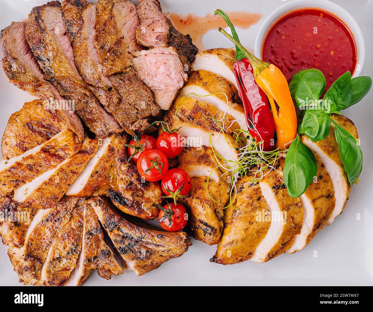 Gourmet grilled meat platter with fresh vegetables Stock Photo - Alamy