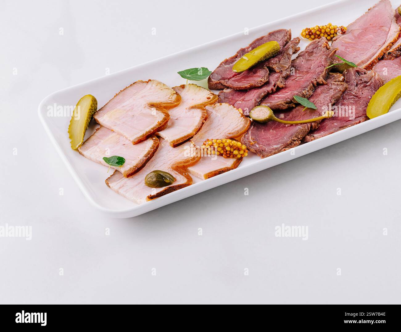 Elegant deli meat platter with sauce Stock Photo - Alamy