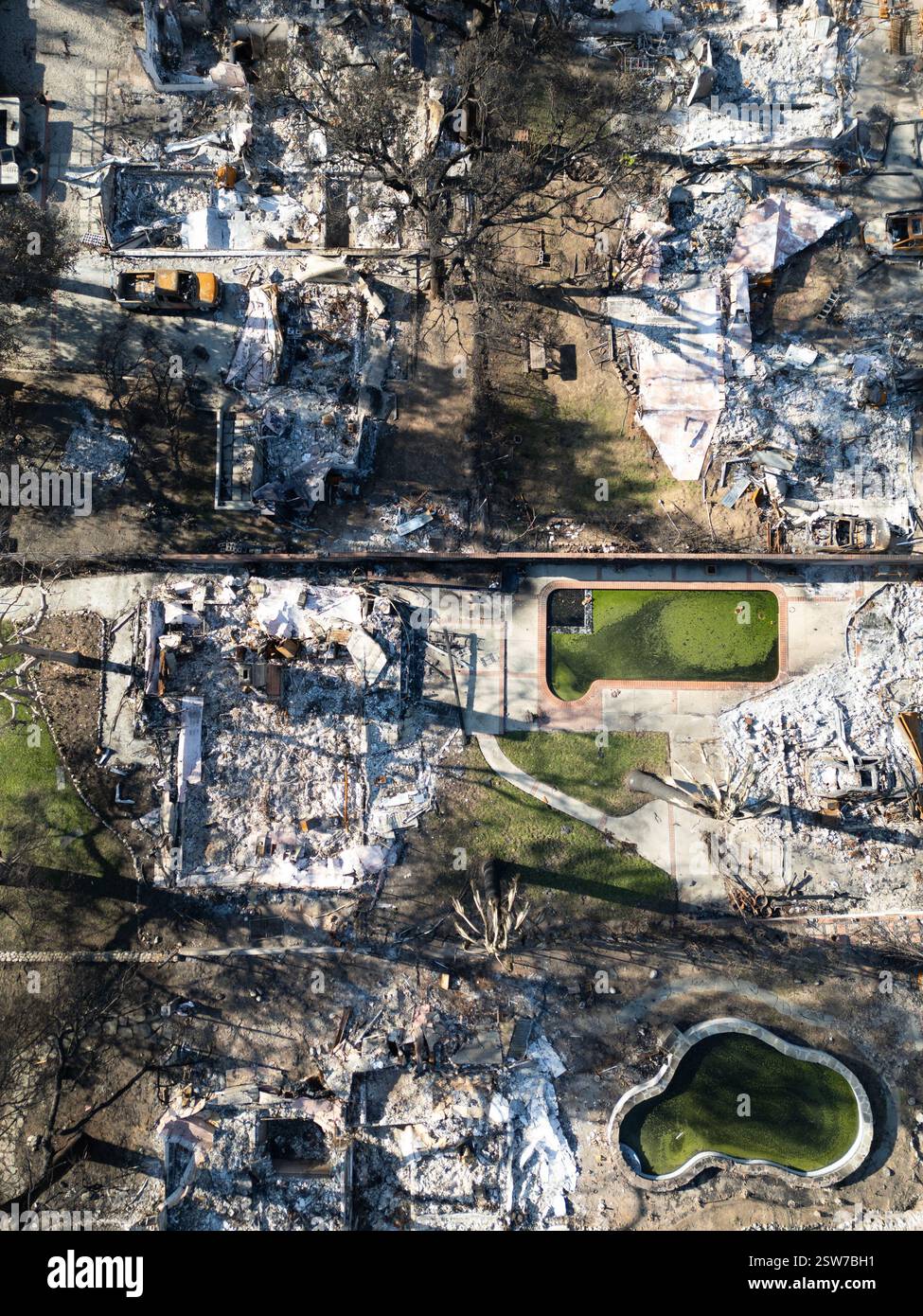 Aerial view looking down on destroyed homes and swimming pools in the ...