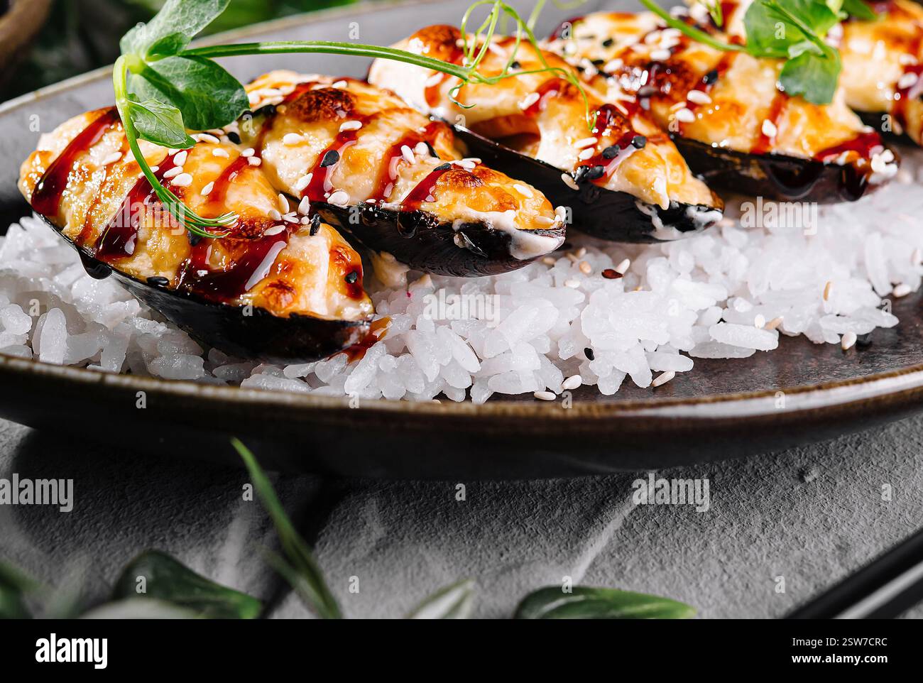Gourmet grilled mussels on bed of rice Stock Photo - Alamy
