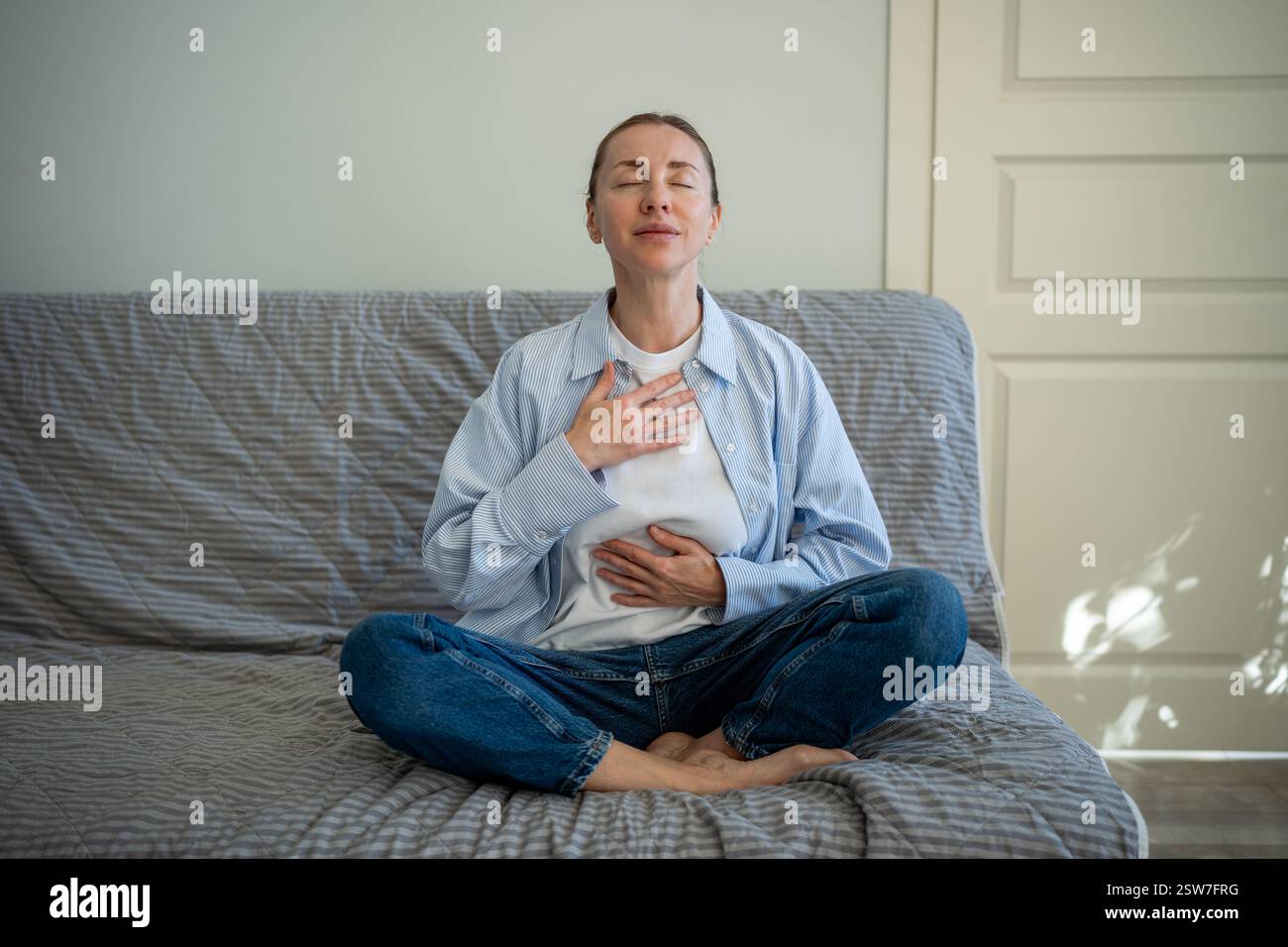 Meditation at home of middle age woman sitting in lotus pose deep ...