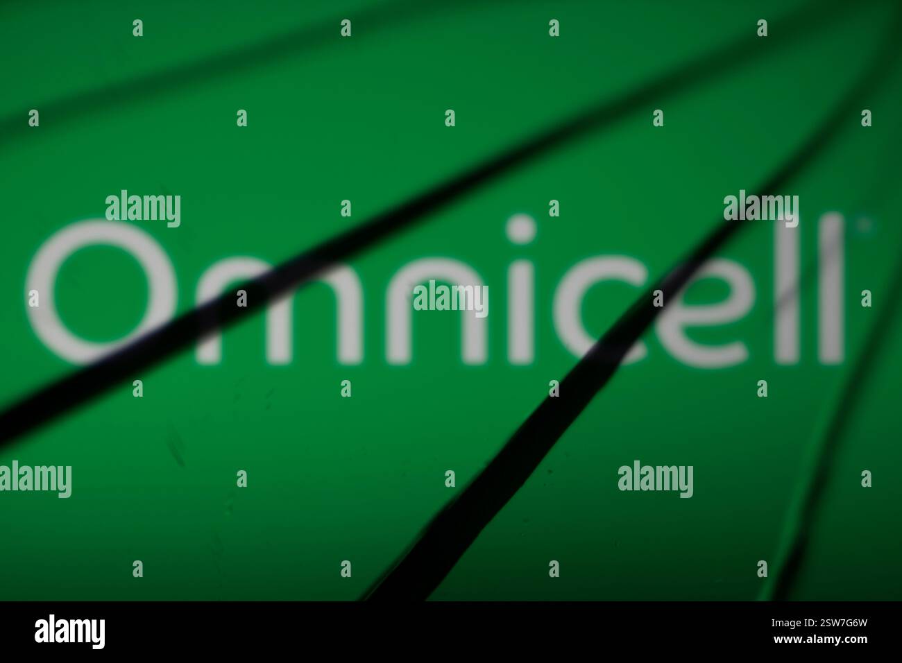 Dhaka, Bangladesh- 15 Oct 2024: Omnicell logo is visible on the broken glass. Omnicell Inc is an ...