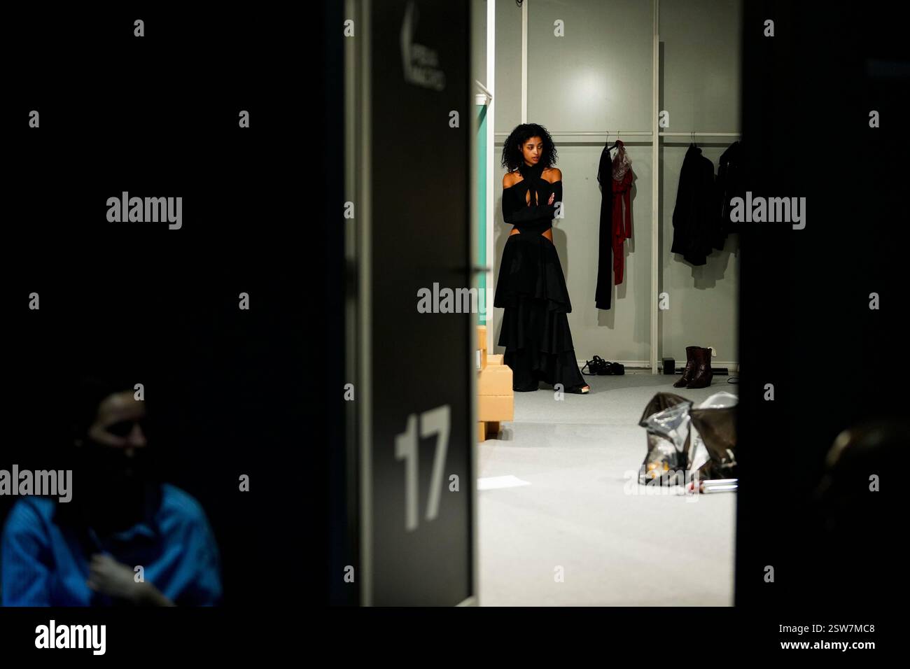 A model waits at a backstage during Fashion Week in Madrid, Spain ...
