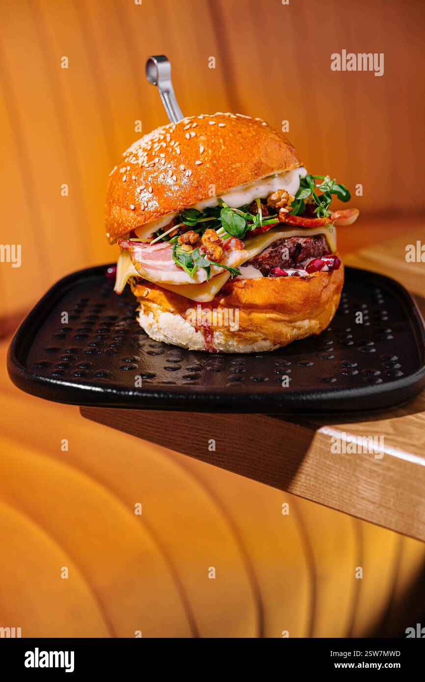 Gourmet burger with artisan toppings on a modern plate Stock Photo - Alamy