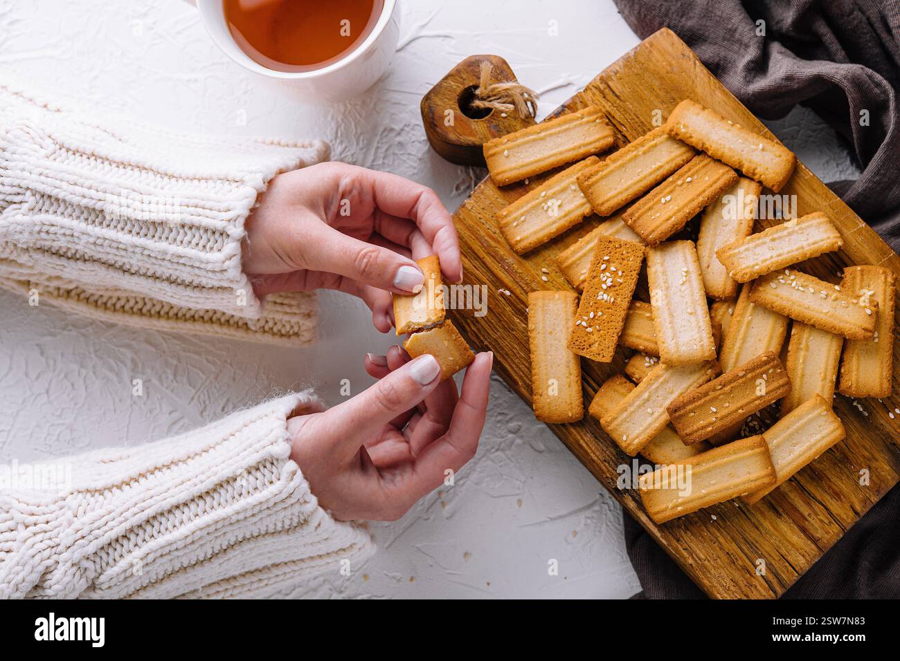 Woman dipping churros in sugar, tea time snack Stock Photo - Alamy
