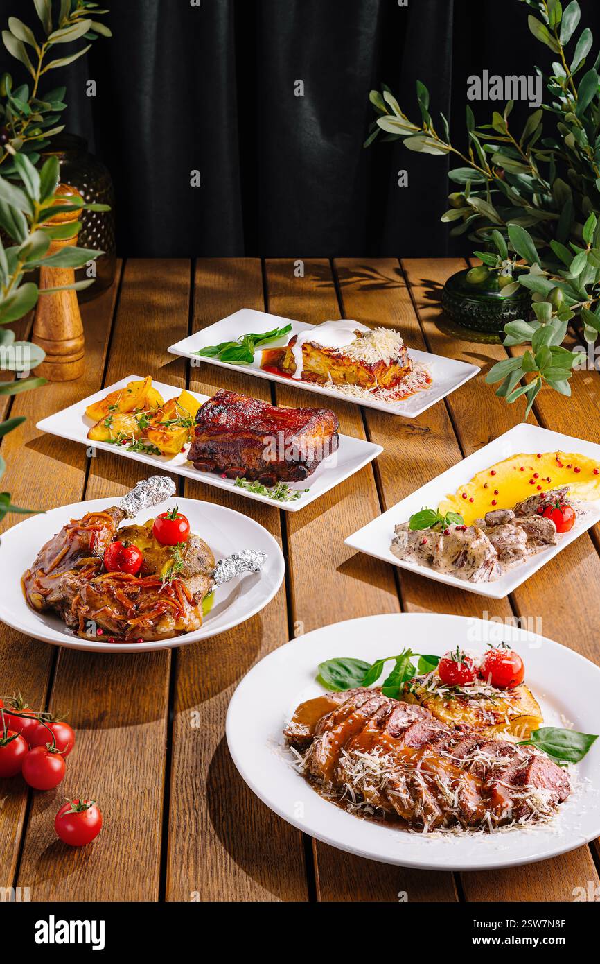 Elegant spread of diverse gourmet meals artfully plated on a rustic ...