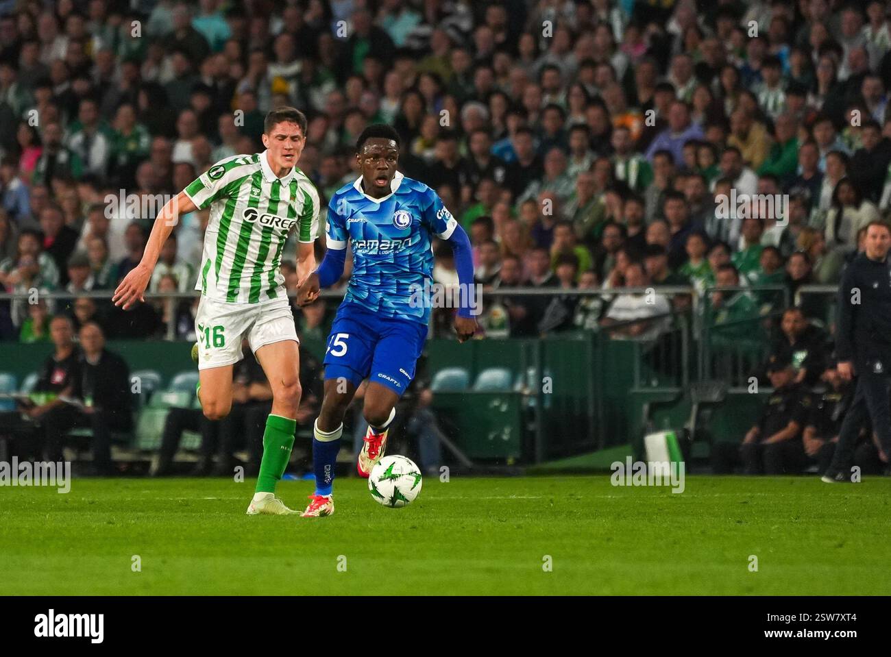 Betis' Sergi Altimira and Gent's Hyllarion Goore fight for the ball ...