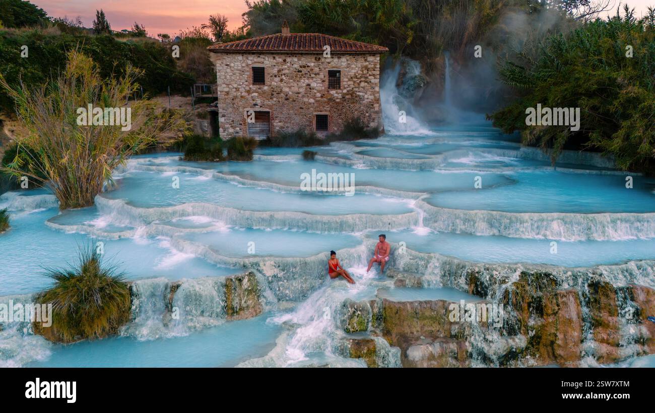 Visitors enjoy the soothing waters of Saturnia thermal baths in Tuscany ...