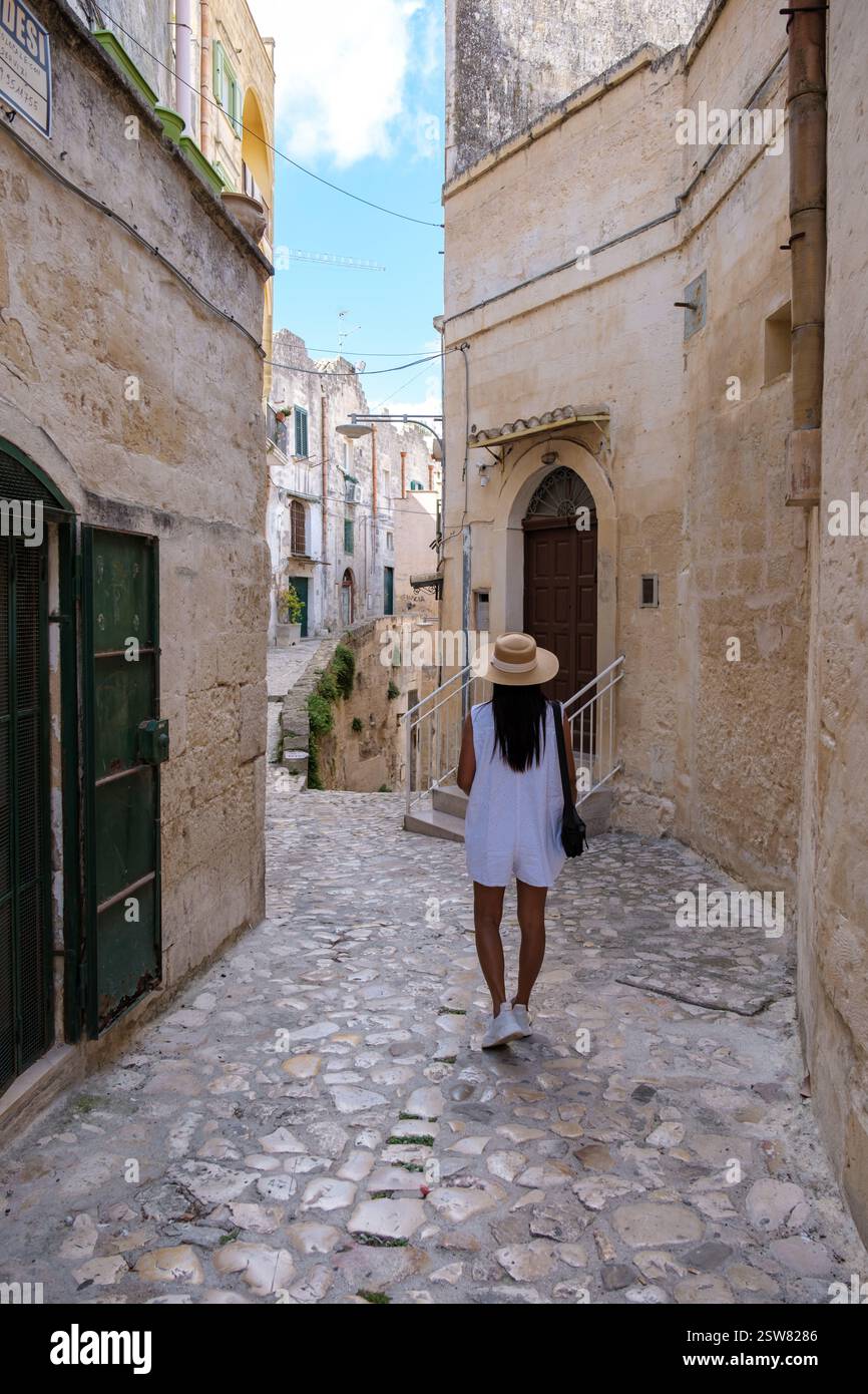 Exploring the charming streets of Matera, Puglia, with a sunhat and ...