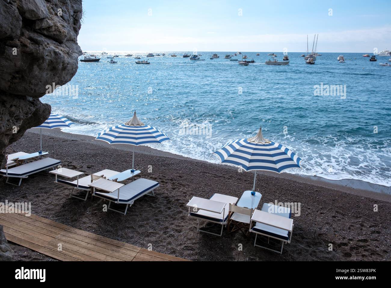 Relaxing beach day on the Amalfi Coast with striped umbrellas and calm ...