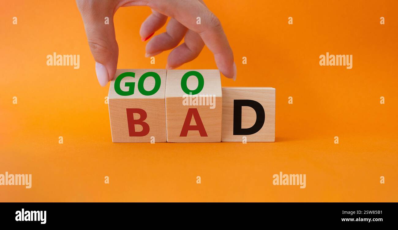 Good vs Bad symbol. Businessman Hand turns cubes and changes word Bad ...