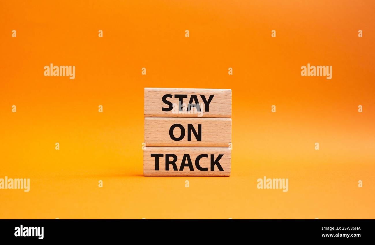 Stay on track symbol. Wooden blocks with words Stay on track. Beautiful ...