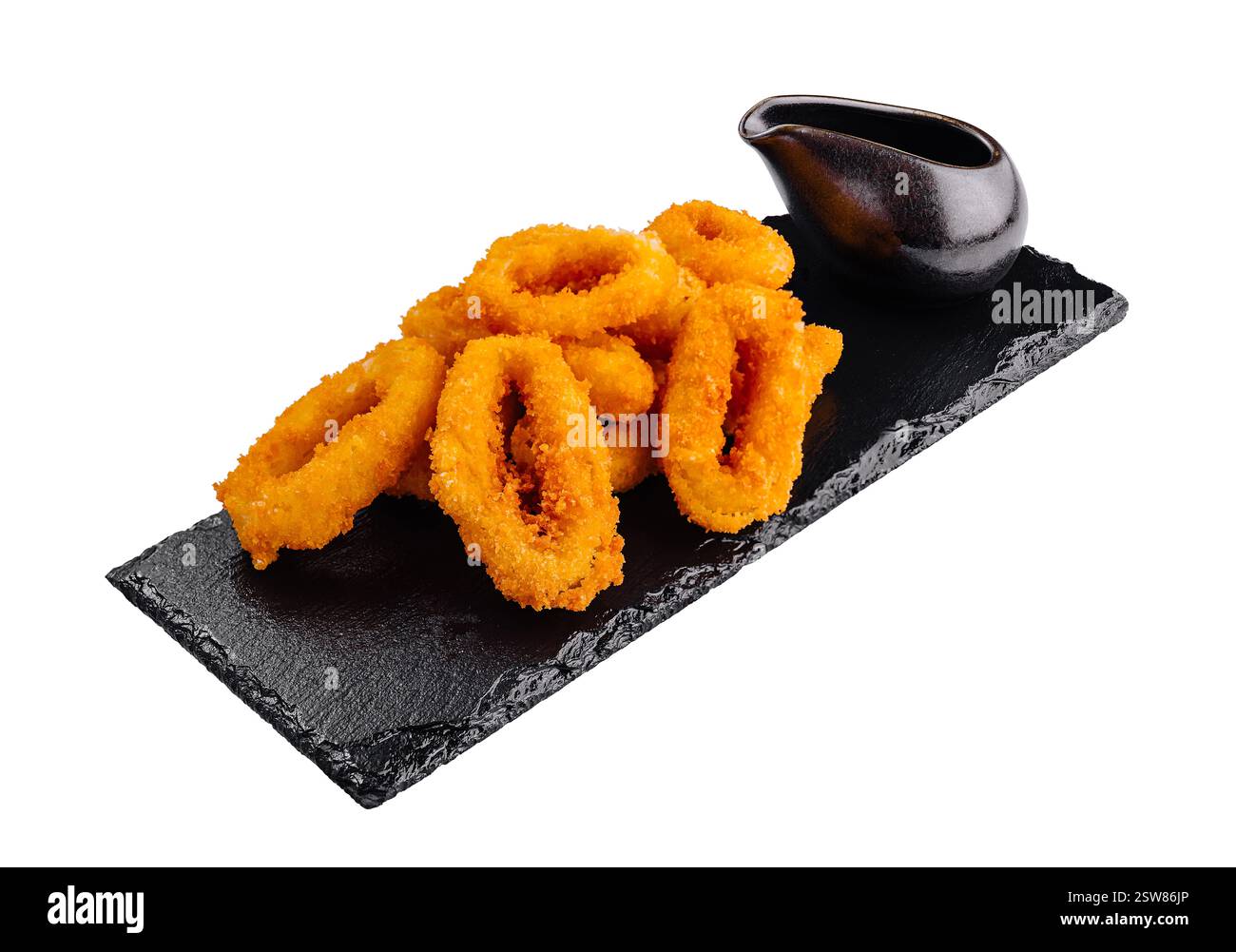 Breaded calamari rings served on black slate with dipping sauce Stock ...