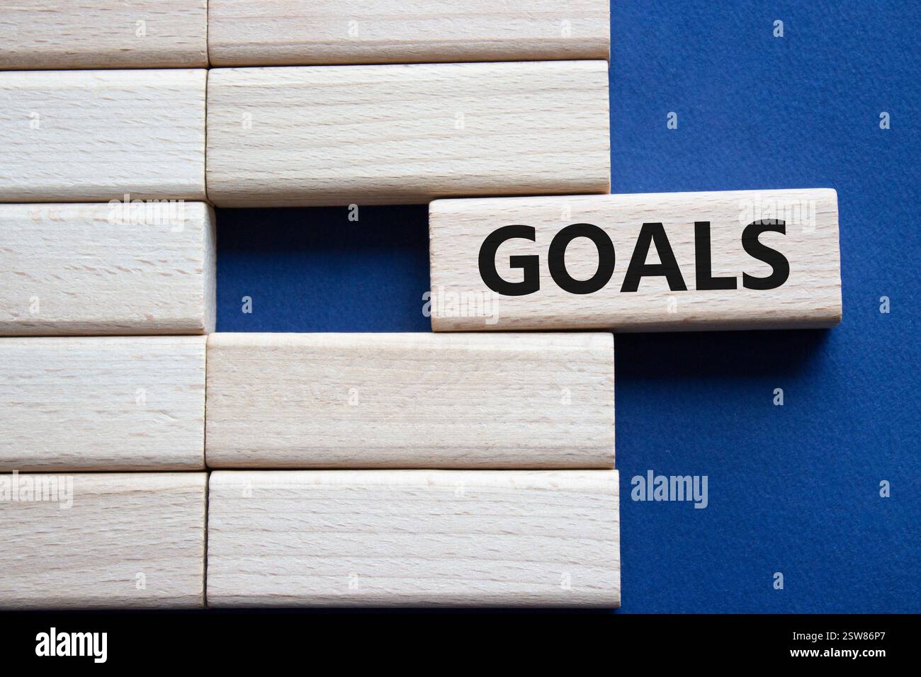 Goals symbol. Concept word Goals on wooden blocks. Beautiful deep blue ...