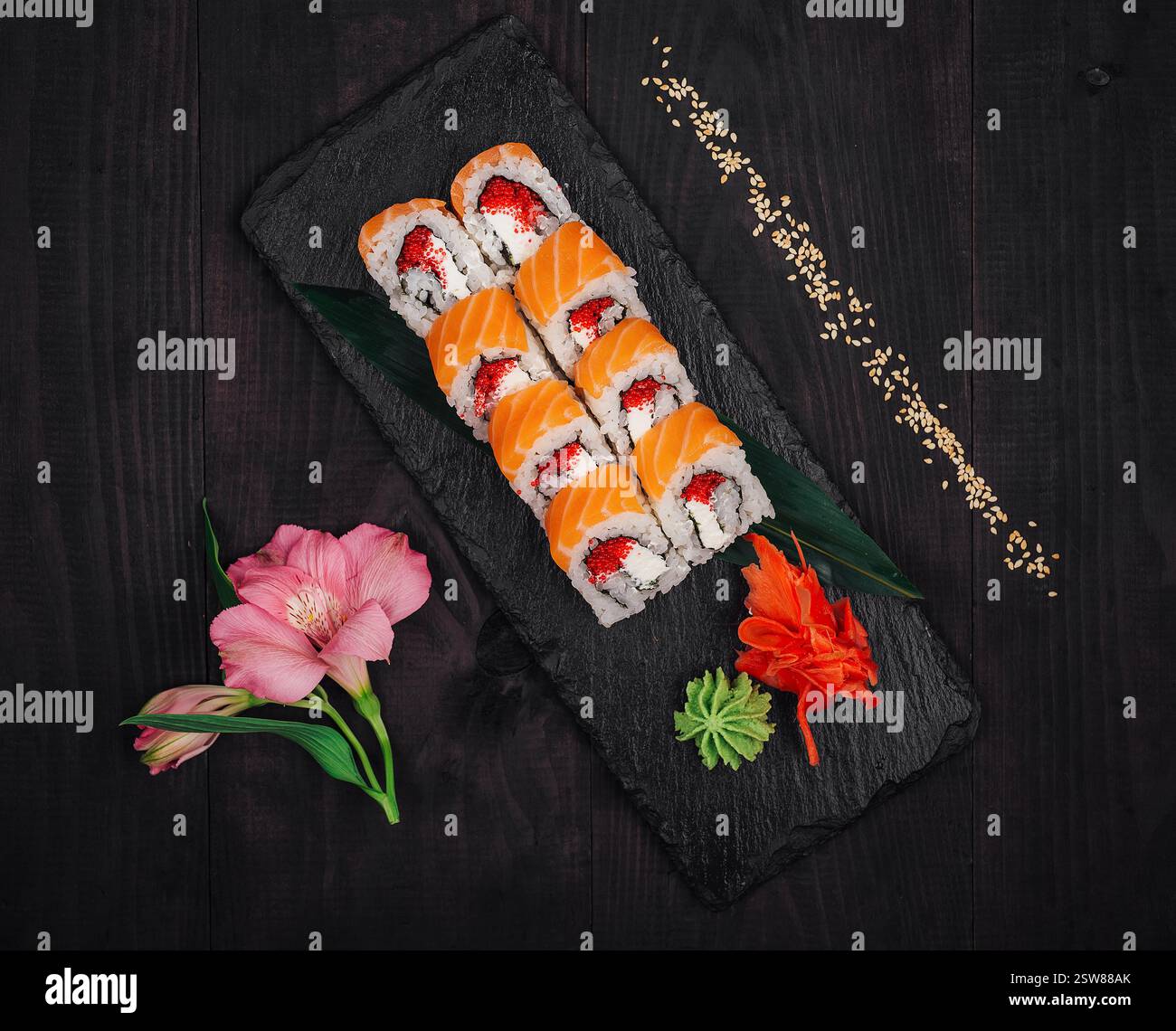 Delicious philadelphia sushi roll decorated with red caviar lying on ...