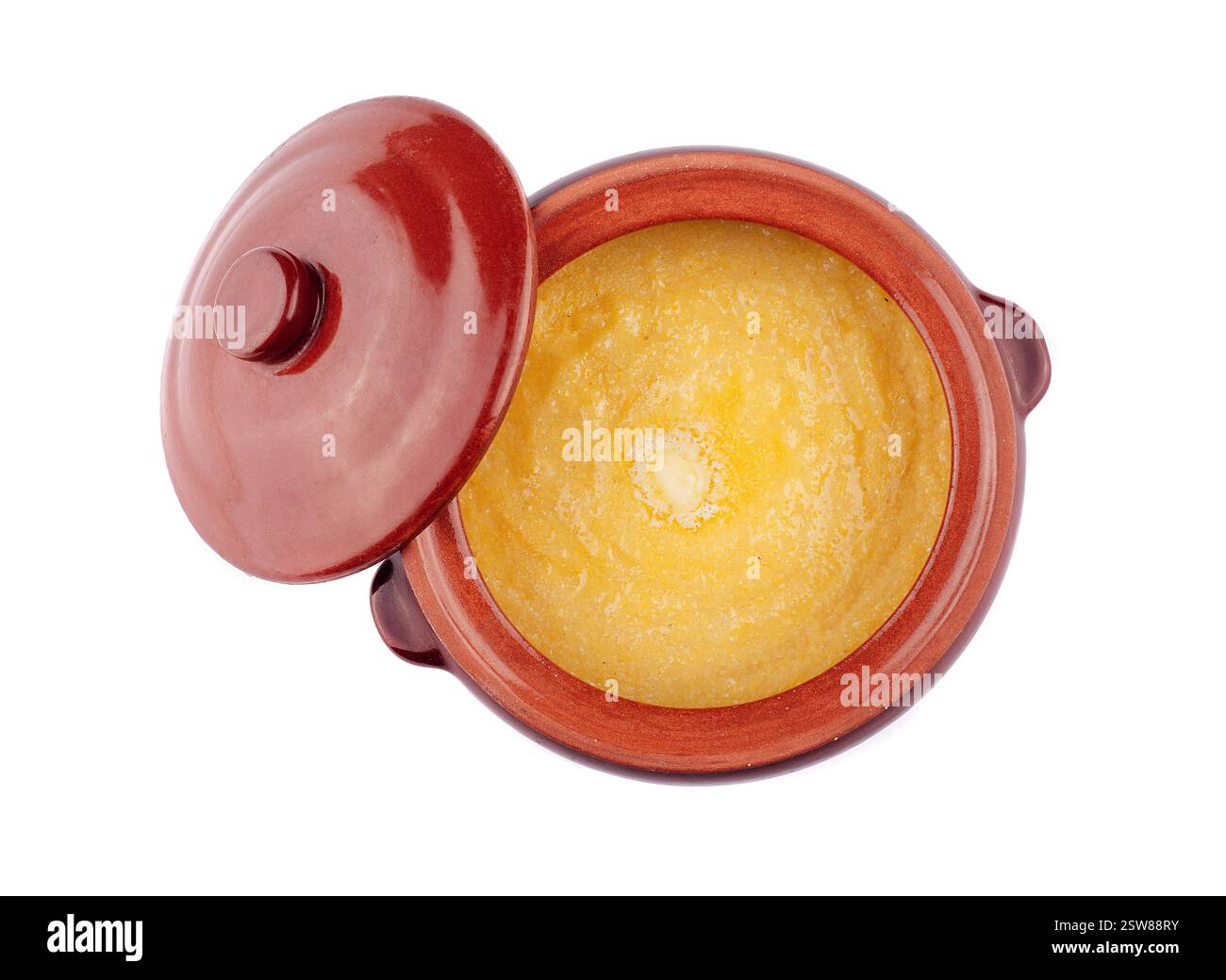 Opened clay pot with hot polenta and melting butter inside Stock Photo ...