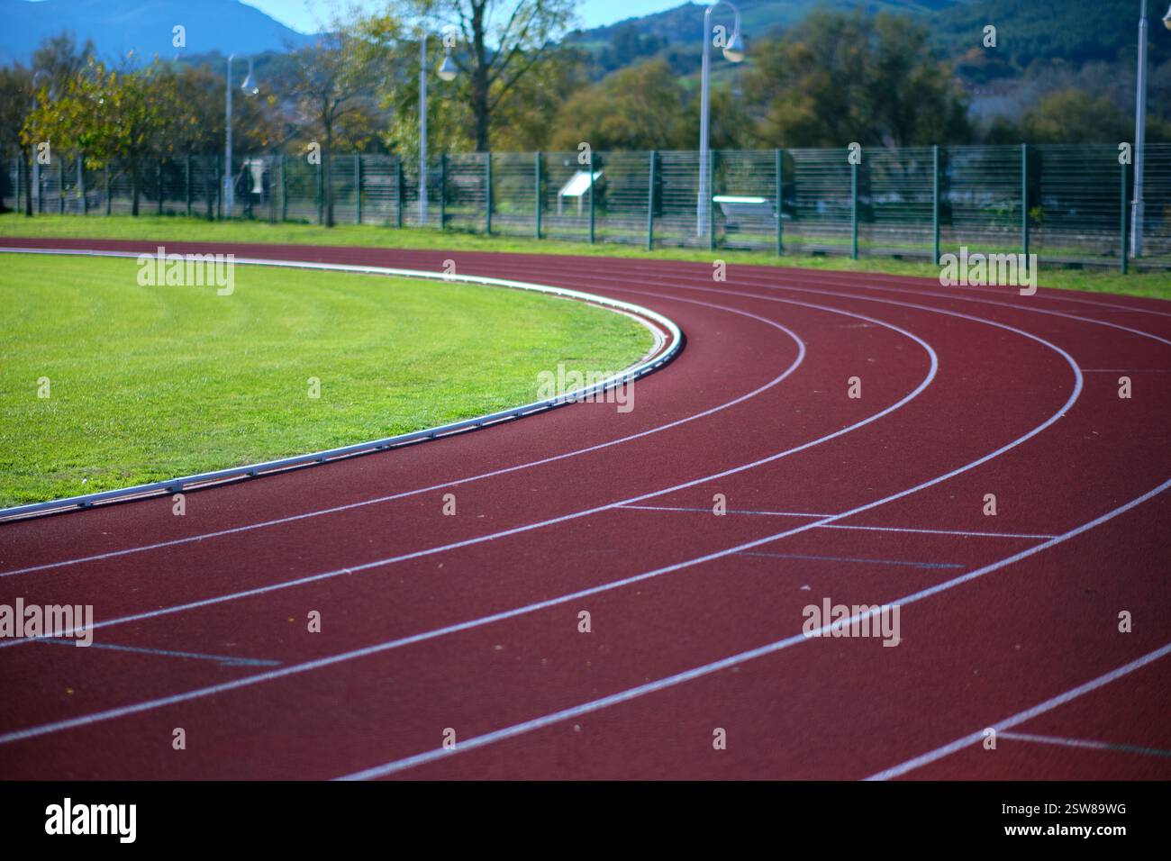 Curved running track in outdoor stadium setting Stock Photo - Alamy