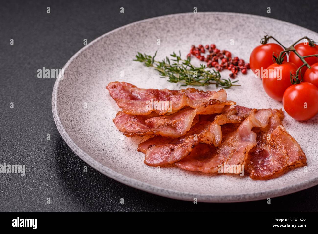 Delicious crispy bacon grilled with salt and spices as an ingredient for a nutritious breakfast ...