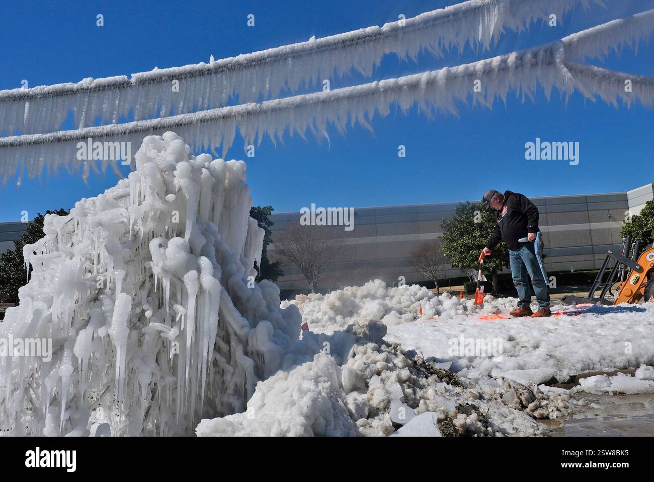 Kelly Turney marks Lumen fiber cable lines that lay under ice caused by ...