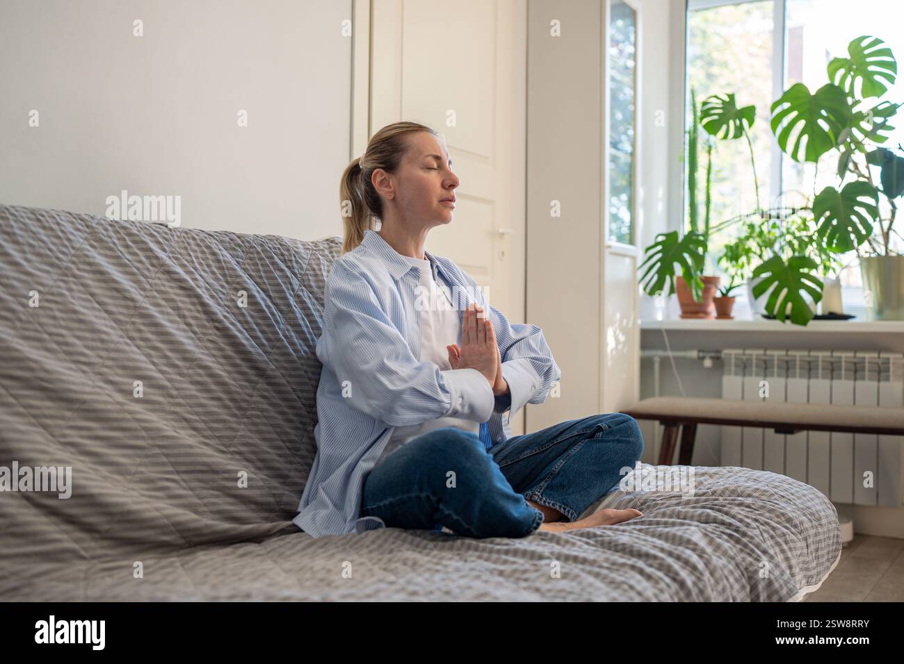 Serene woman with clasped hands, meditating in Yoga lotus Asana. Self ...