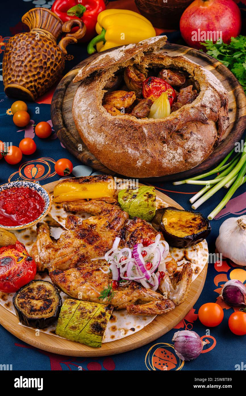 Traditional georgian cuisine with grilled chicken, vegetables and baked ...