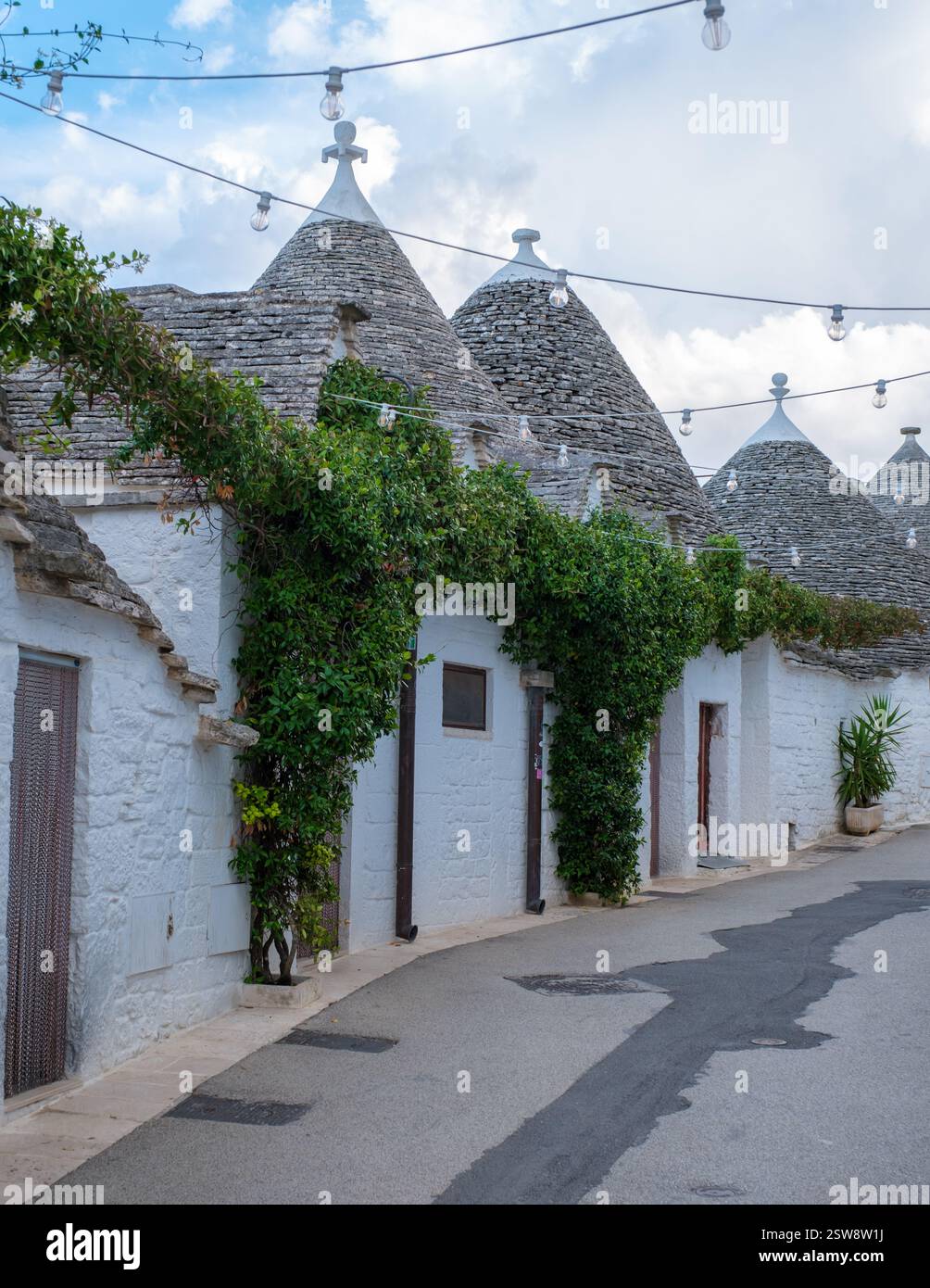 Alberobello Winding through a quiet street in Puglia, enchanting trulli ...