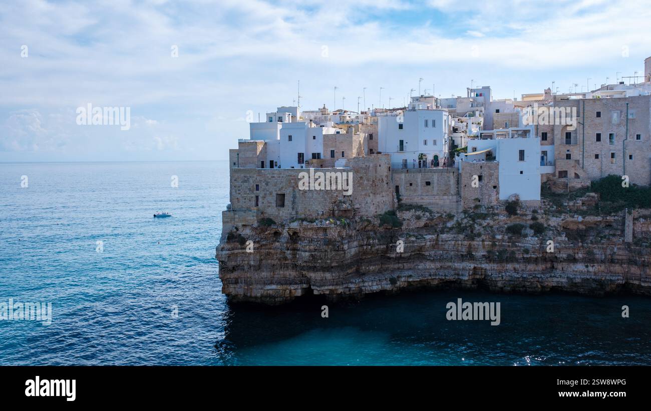 Charming coastal town of Polignano a Mare cliffs against the sparkling Adriatic Sea in Puglia ...