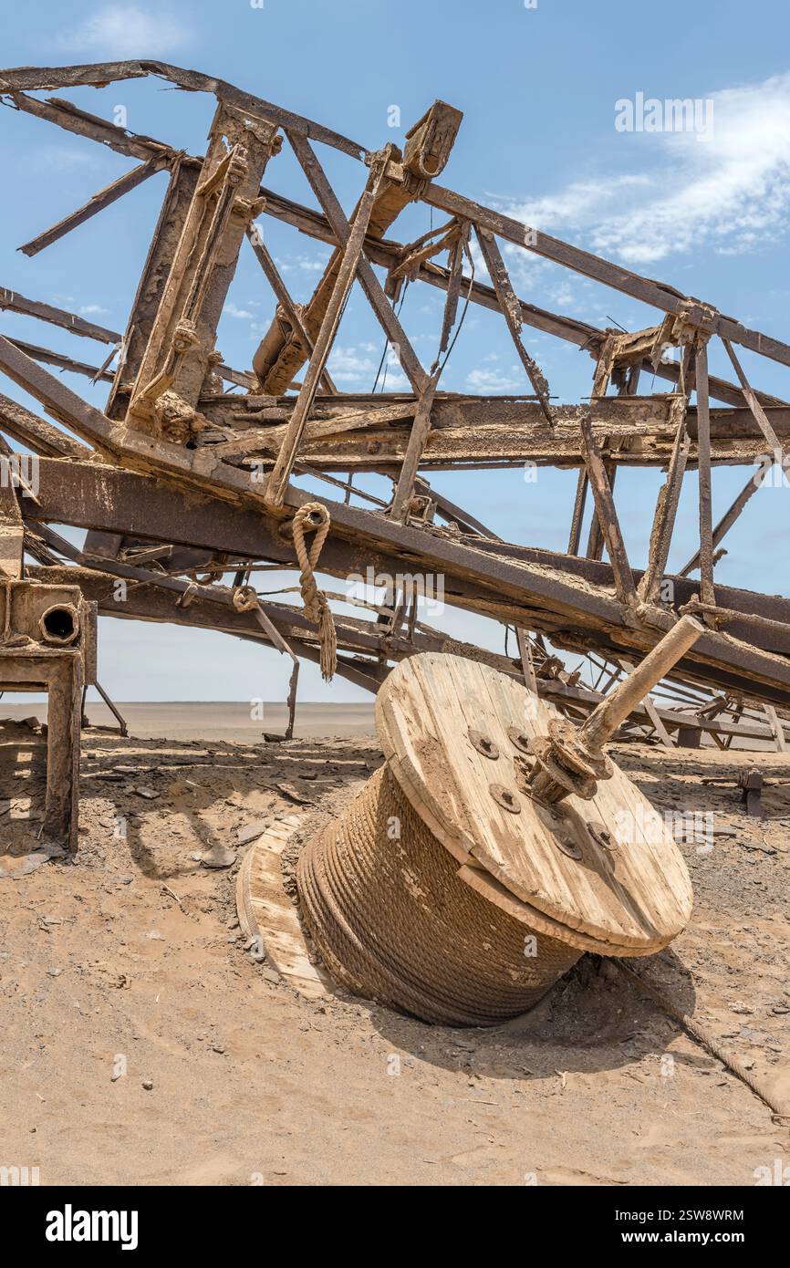 wire reel and derrick of Drill Rig relic on desert sand, shot in bright ...