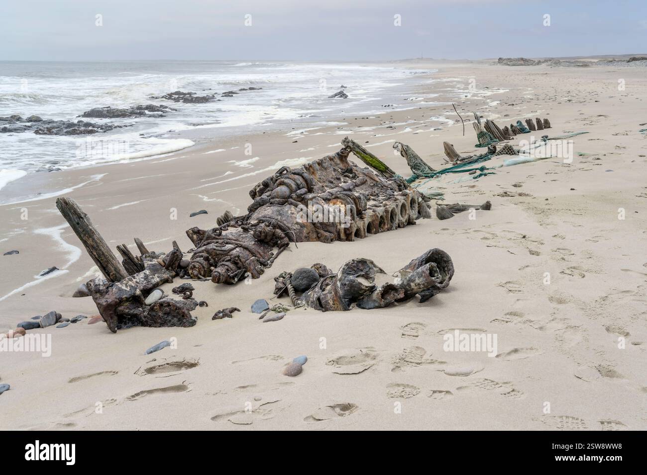 landscape with remains of sunken ship at Ocean shore of desert coast ...