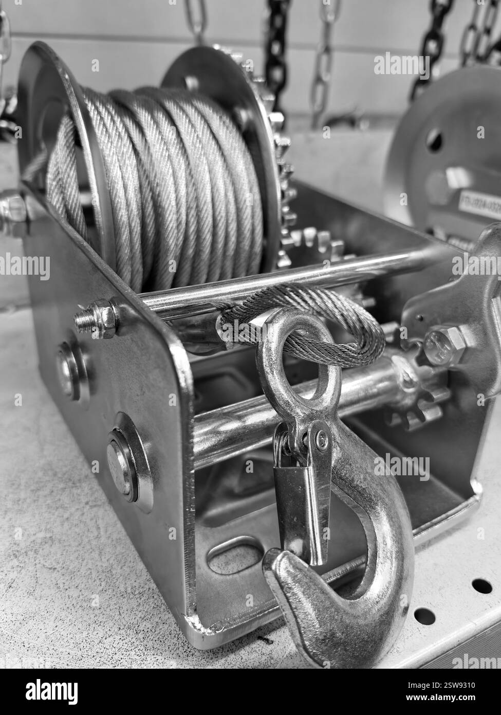 A close-up view showcases a sturdy winch with a shiny hook, surrounded ...