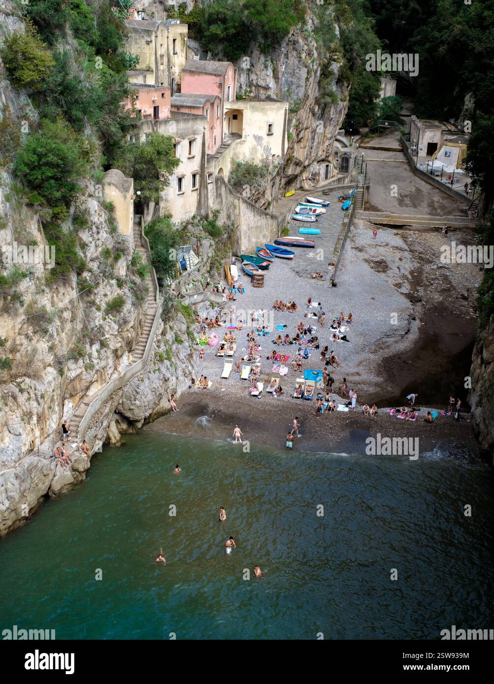 Sunbathers enjoy the picturesque hidden beach on the Amalfi Coast ...