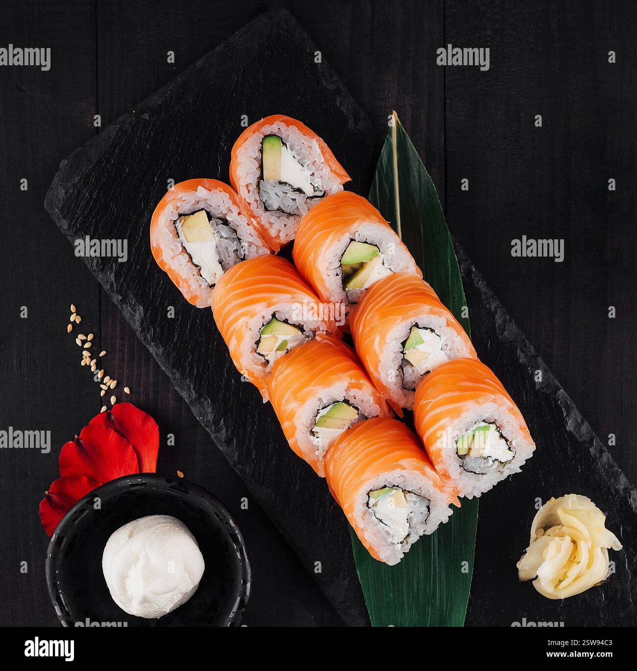 Philadelphia sushi roll serving on black stone plate Stock Photo - Alamy