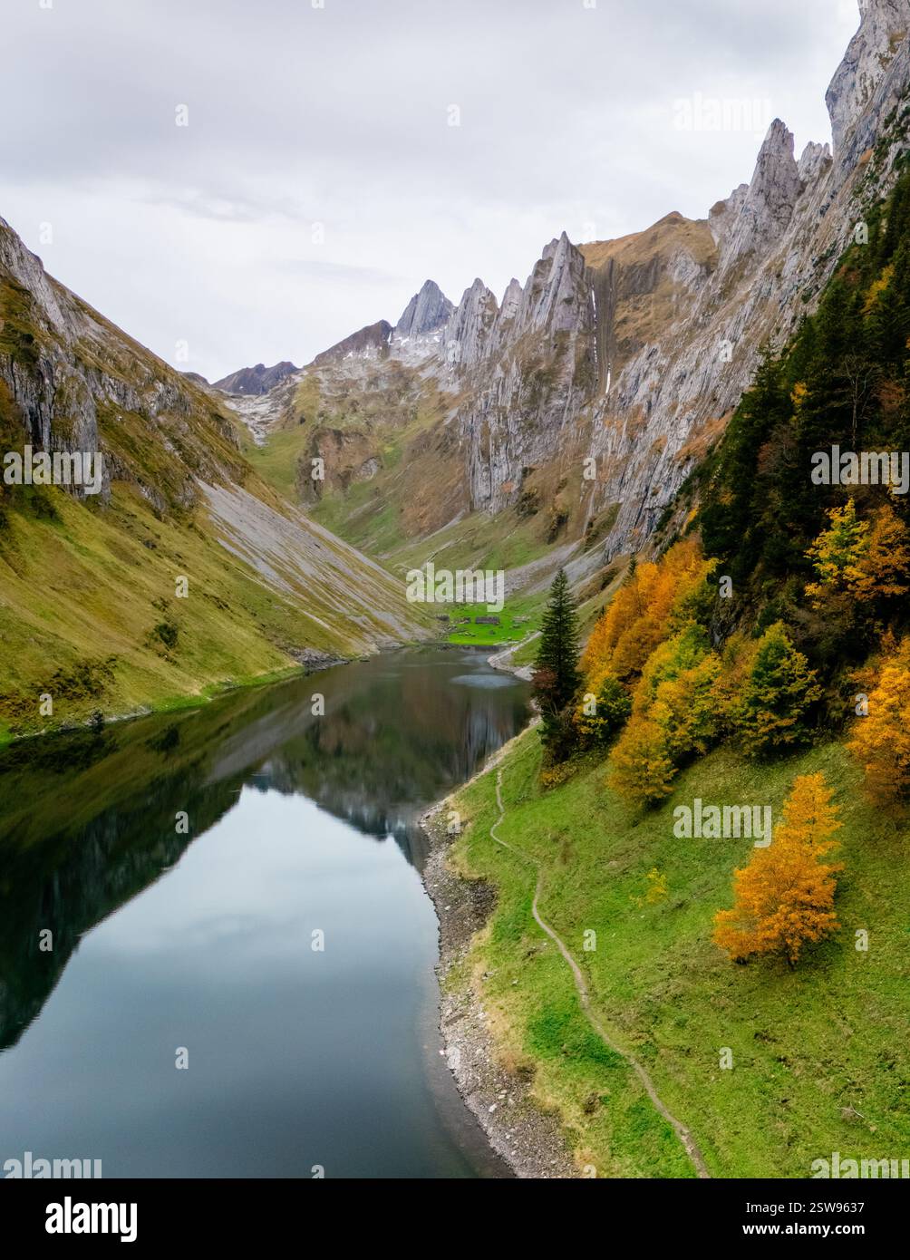 Nestled between towering peaks, Falensee reflects the tranquil waters ...