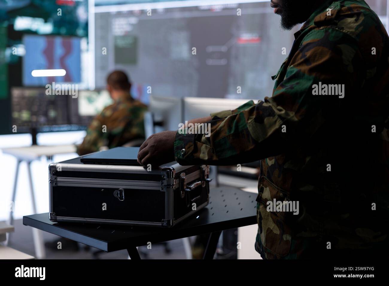 Military staff in a high tech command post gathers intelligence for crucial defense operation ...