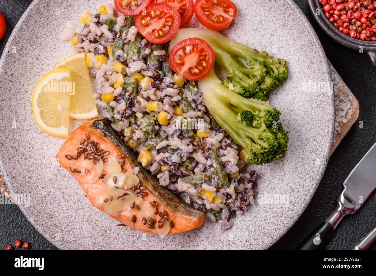 Grilled salmon with salt and spices, broccoli, tomatoes, rice Stock ...